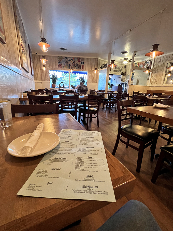 Step inside and you're transported to a cozy ship's cabin, where pendant lights cast a warm glow over wooden tables that have hosted countless chowder epiphanies.