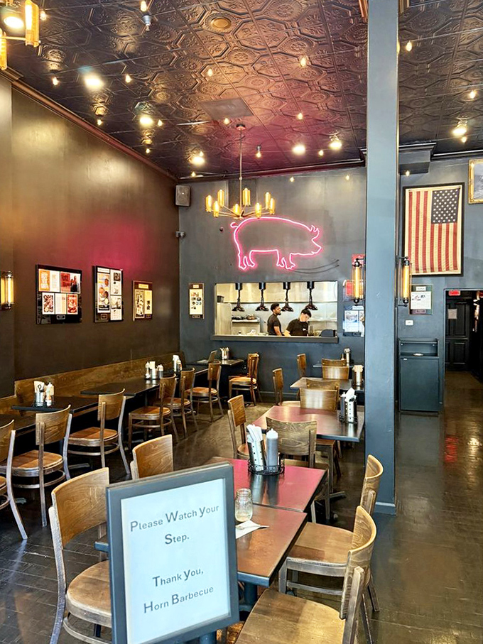 Inside, ornate tin ceilings meet industrial chic, while that neon pig silently promises delicious things to come. Barbecue church is in session.