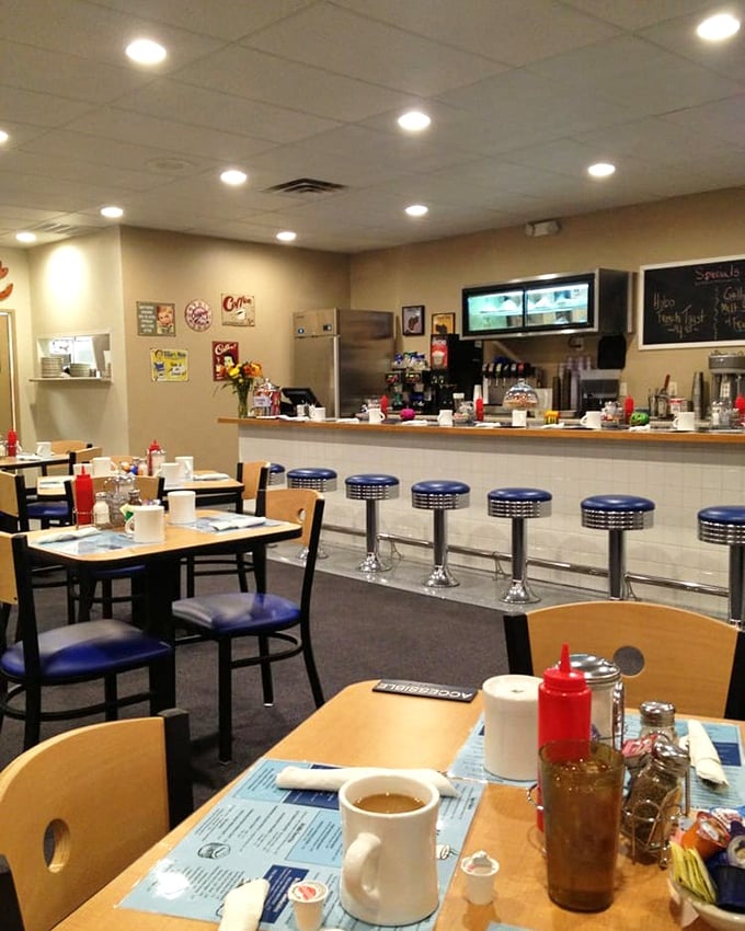 Classic blue counter stools await the solo diner, the morning paper reader, the coffee philosopher. In diners like this, strangers become neighbors over bottomless cups.