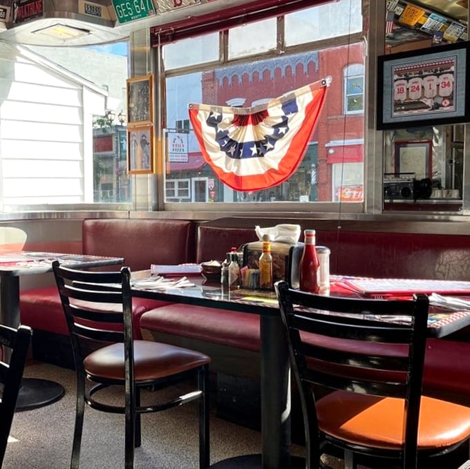 Classic red vinyl booths and patriotic bunting create the perfect backdrop for breakfast conversations that flow as freely as the coffee.