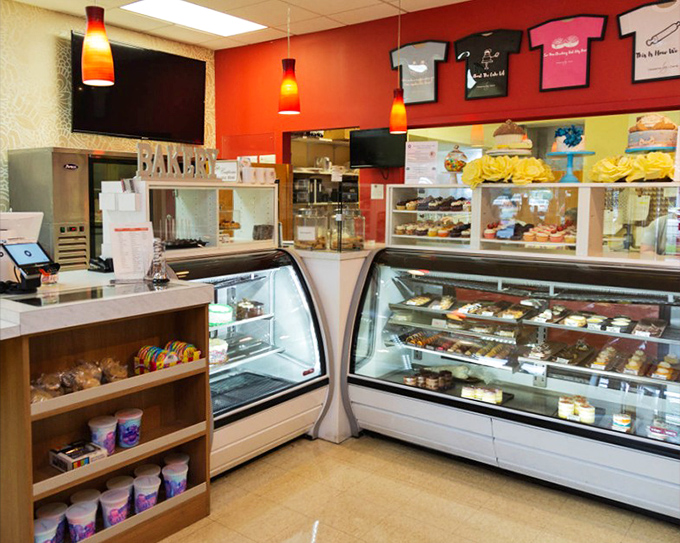 Inside, the vibrant red walls and gleaming display cases create a warm welcome. Those pendant lights aren't just illuminating pastries&mdash;they're spotlighting edible art.