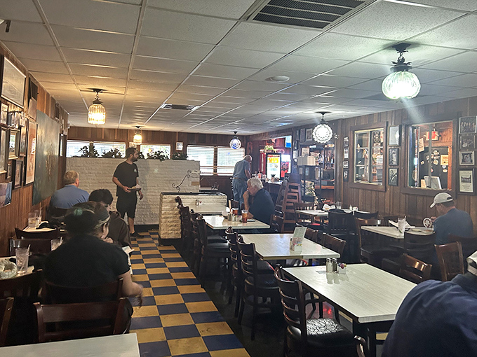 Step inside and the checkerboard floor practically shouts "we've been here forever!" Wood paneling and globe lights create that perfect "abuela's dining room" vibe we all crave.