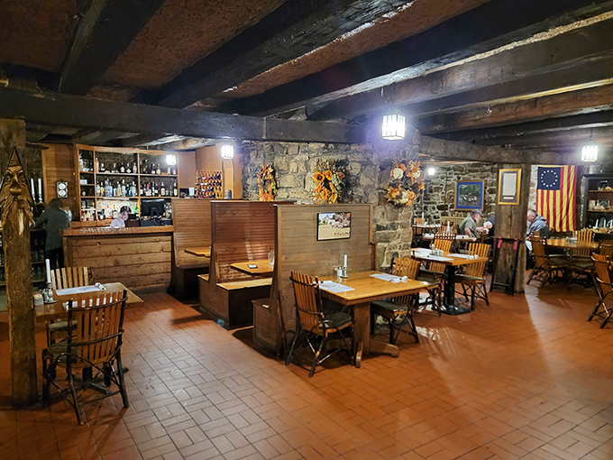 Low ceilings, exposed beams, and original stonework create an atmosphere that's genuinely colonial, not theme-park colonial.