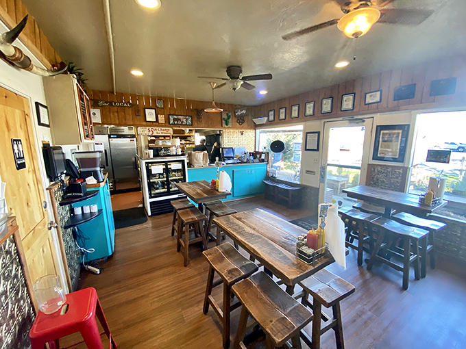 Inside, rustic wooden tables and that signature turquoise counter create the perfect backdrop for life-changing burger experiences and conversations worth remembering.