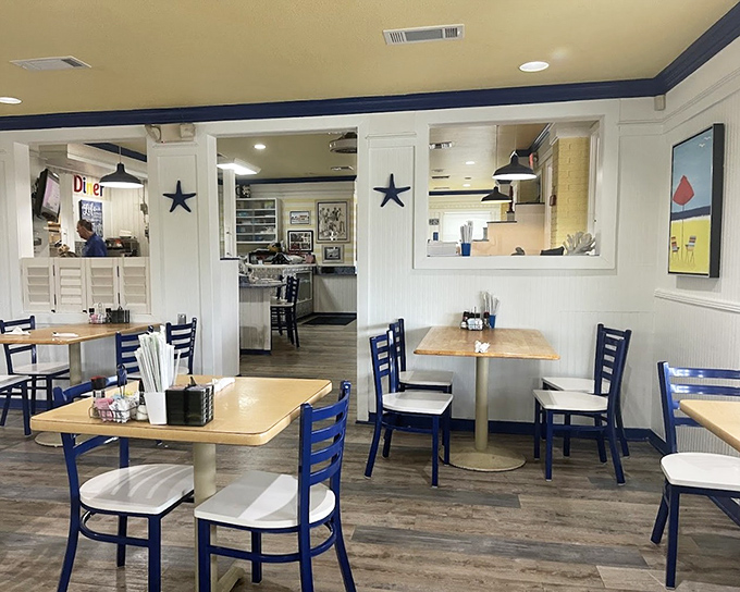 Navy blue accents pop against crisp white walls in this nautical-themed interior where breakfast is serious business and every table feels like the captain's table.