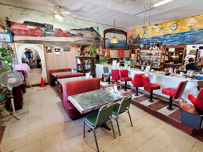 Classic red vinyl booths and hand-painted murals transport you to simpler times, when conversations happened face-to-face and coffee came without complicated names.