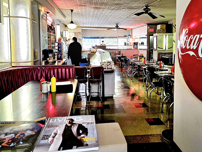 Step inside and the 1950s never ended. Red vinyl booths, checkered floors, and that unmistakable Coca-Cola glow&mdash;comfort before you even order.