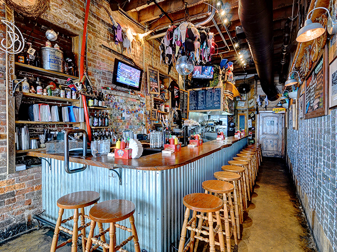 The heart of burger paradise: exposed brick, corrugated metal, and wooden stools create the perfect backdrop for life-changing food decisions.