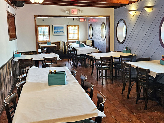 Nautical charm meets cozy comfort inside with porthole windows and simple white tablecloths. It's like dining in the captain's quarters of a beloved fishing vessel. 