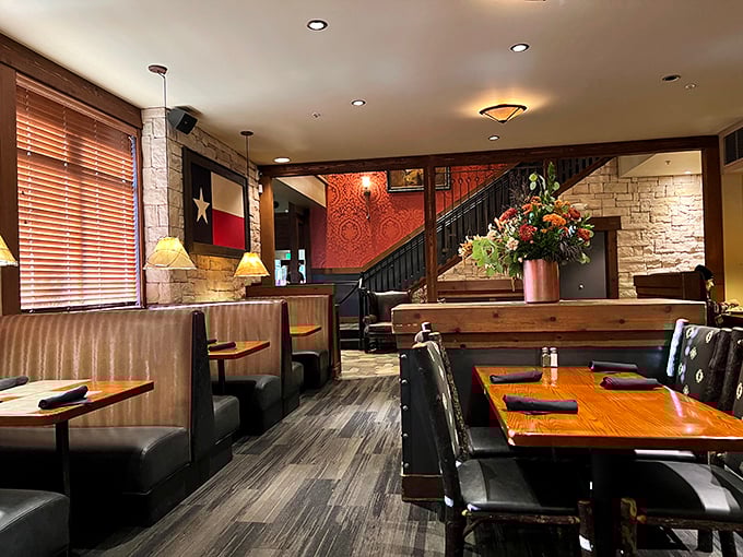 Stone walls, leather booths, and Texas flags create an atmosphere that whispers, "Slow down, partner. Good barbecue can't be rushed."