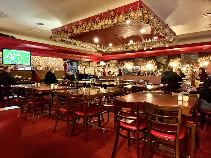 Inside Loui's, hundreds of Chianti bottles dangle from the ceiling like delicious stalactites in a cave of culinary wonders.