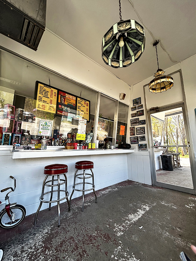 Vintage pendant lights and red bar stools create a timeless atmosphere where conversations flow as freely as the milkshakes.
