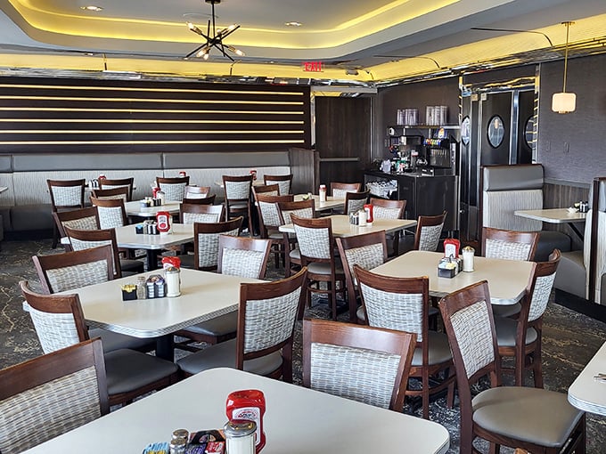 Comfortable booths and warm lighting create that perfect diner atmosphere where conversations flow as freely as the coffee. A sanctuary of comfort. 