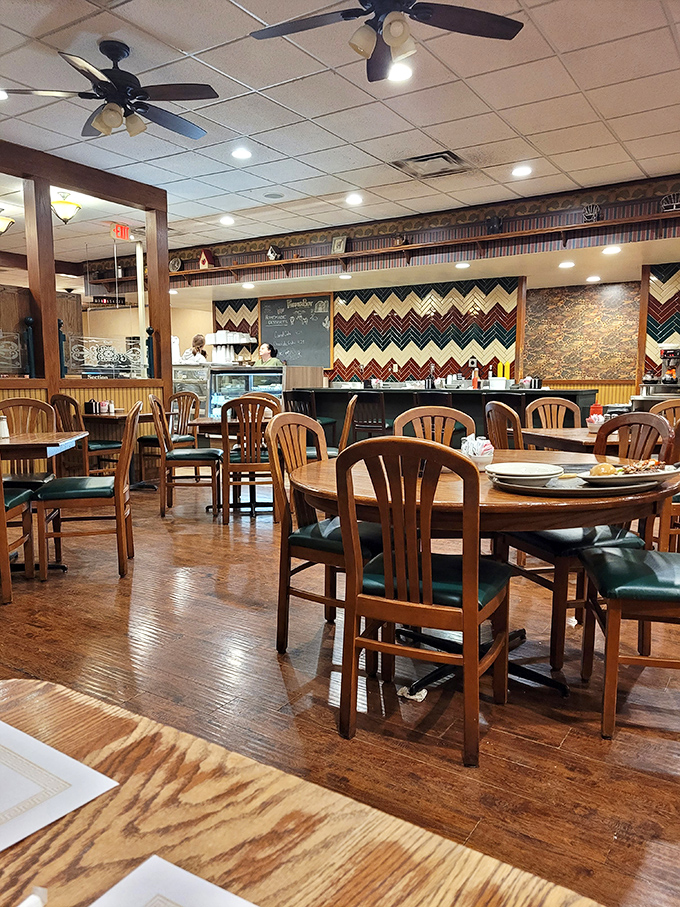 Classic wooden chairs and chevron-patterned walls create that perfect "been here forever" vibe where conversations flow as freely as the coffee.
