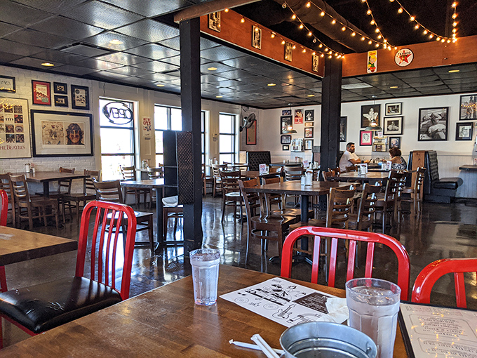 Red chairs pop against wooden tables while string lights create that "everybody knows your name" atmosphere diners dream about.