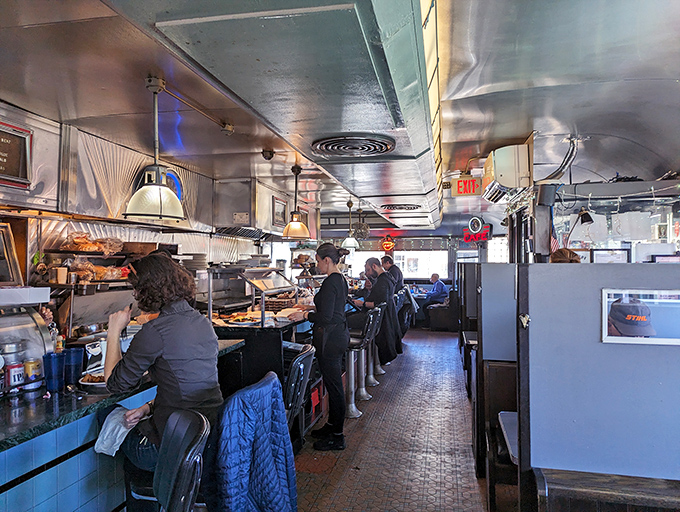 The narrow counter offers front-row seats to the breakfast ballet—where short-order cooks perform their griddle choreography with practiced precision.