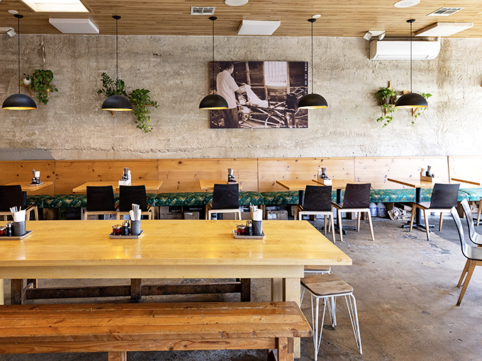 Concrete walls meet warm wood in this minimalist haven where plants dangle like edible art installations.