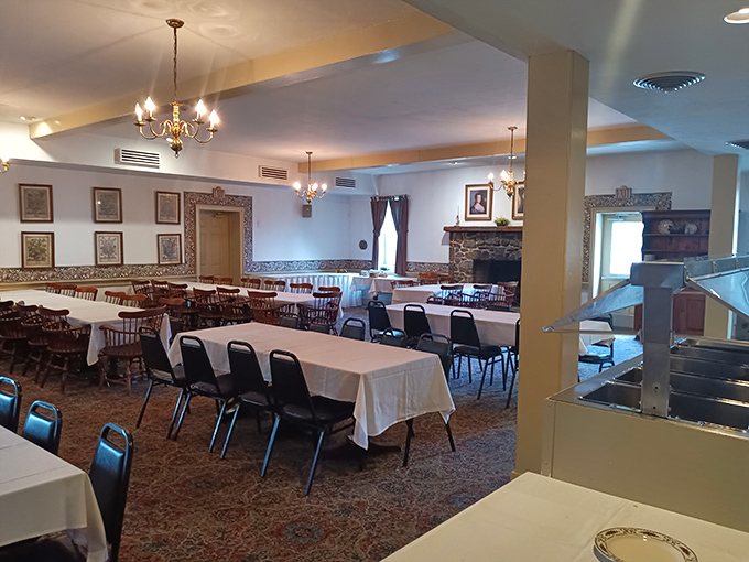 White tablecloths await hungry history buffs in this dining room where chandeliers cast a warm glow over conversations that bridge centuries.