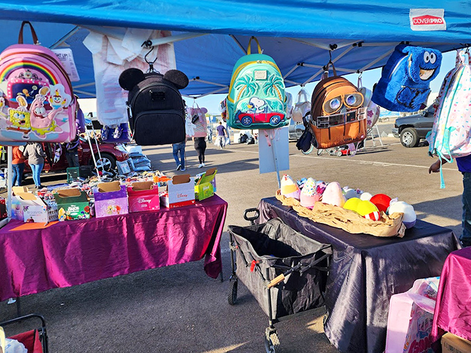 Colorful character backpacks dangle like bait for young shoppers. Cookie Monster, Mickey, and friends wait to carry home someone's school supplies and dreams.