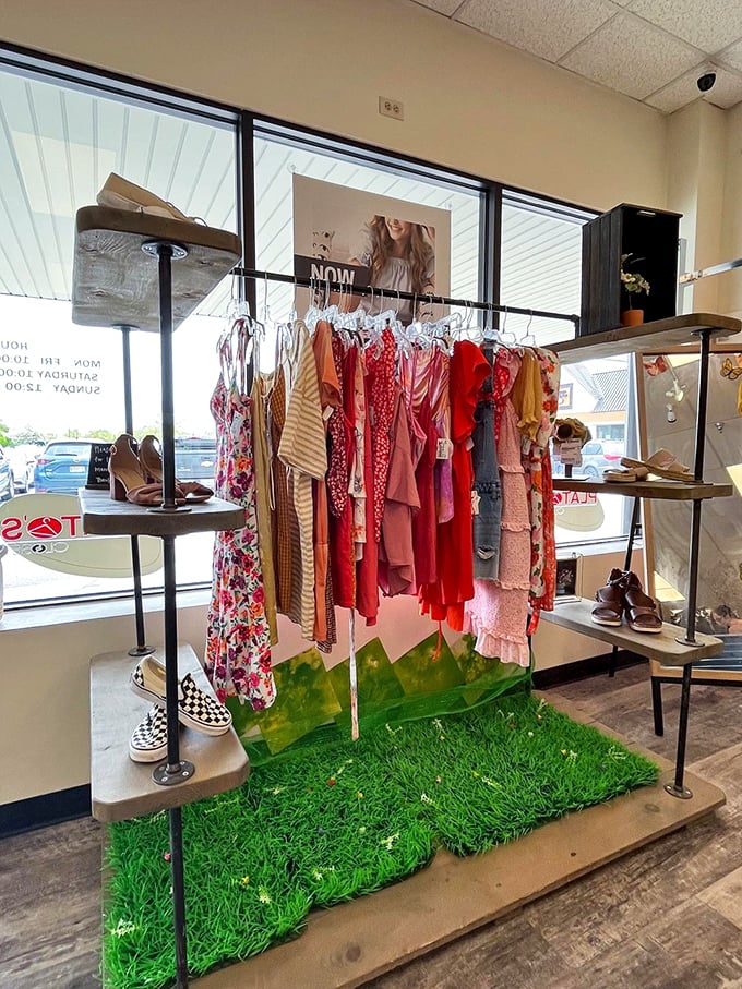 Spring fashion blooms year-round on this creative display, where floral dresses stand atop artificial grass&mdash;retail theater at its thriftiest.