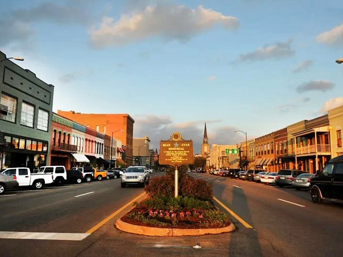 Main Street at golden hour &ndash; where the historic marker reminds you that you're walking through living history, not just another pretty downtown.