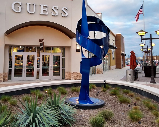 Art meets retail at the GUESS storefront, where this striking blue spiral sculpture proves shopping centers can feed both your closet and cultural appetite.