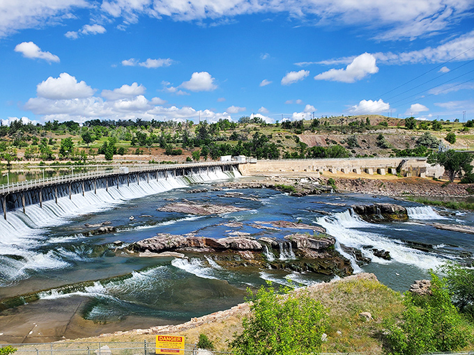Where engineering meets nature's power. The dam creates a dramatic backdrop to the Missouri River's journey, with layered falls that hypnotize visitors.