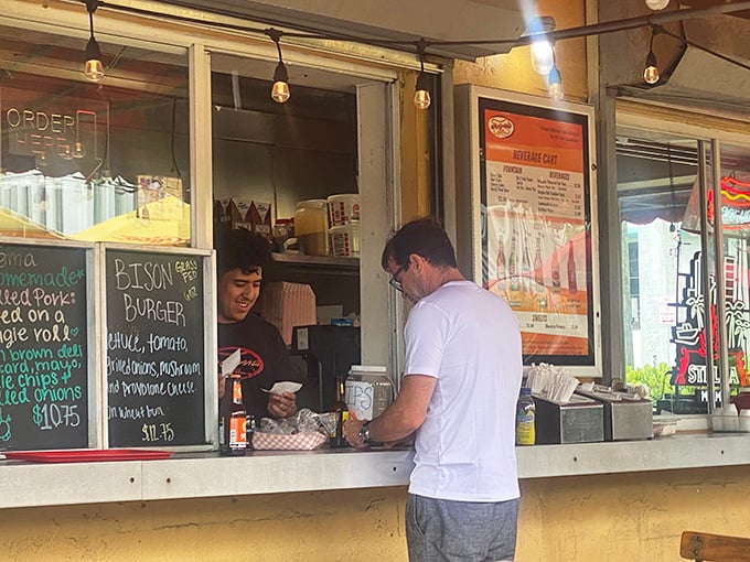 The sacred exchange: order at window, receive happiness. That moment of anticipation when Miami's best-kept cheesesteak secret is just minutes away.