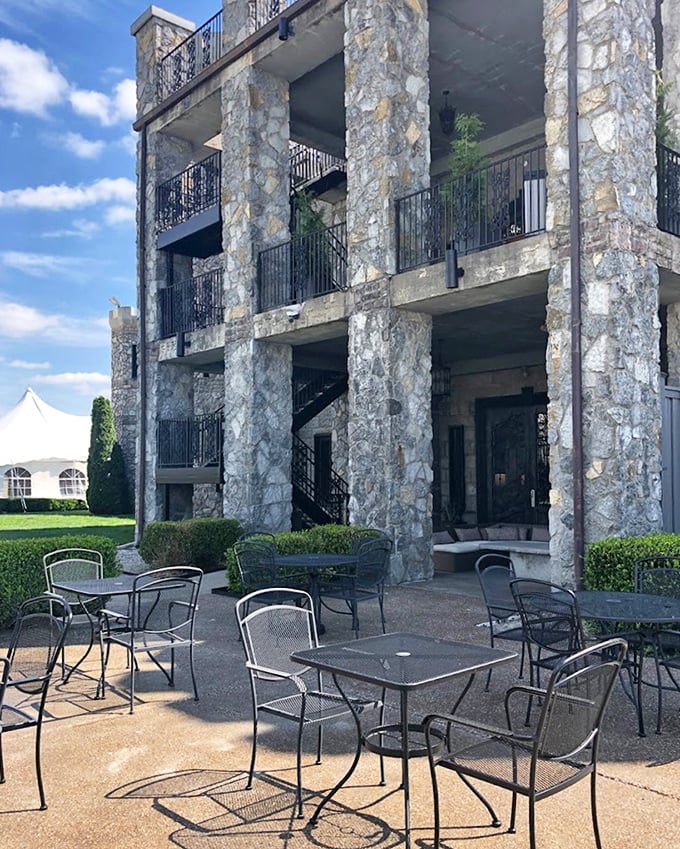 Stone pillars and wrought iron furniture create an outdoor sanctuary where you can sip bourbon while pretending you're medieval royalty.