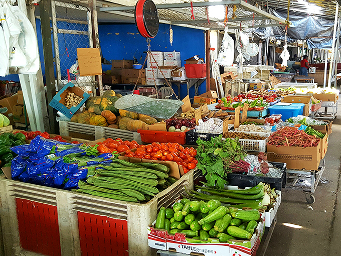 Fresh produce bursting with color creates an impromptu farmers' market within the flea market. Those tomatoes look like they're auditioning for a still-life painting!