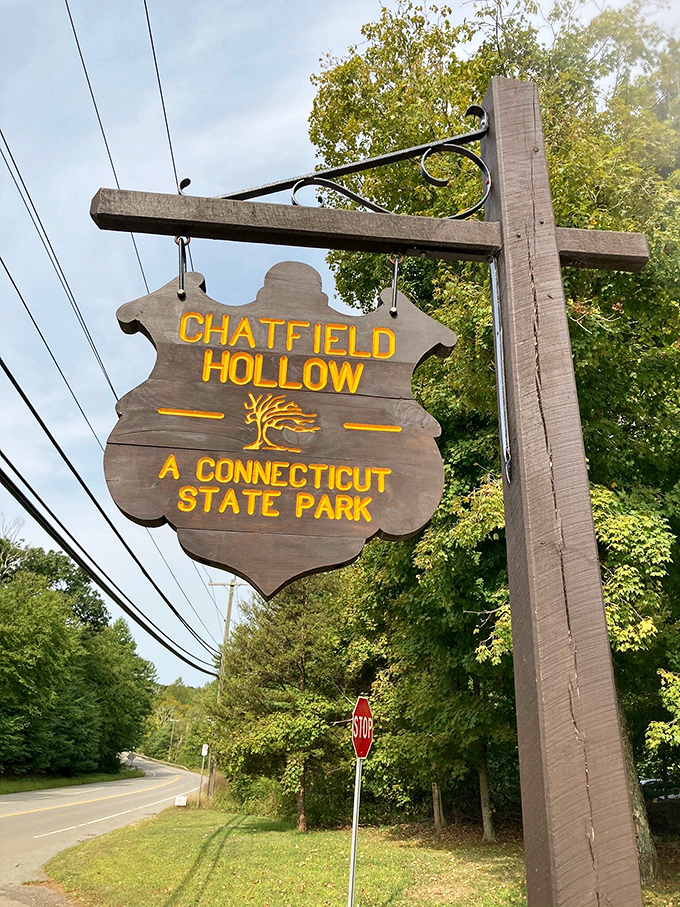 This wooden welcome sign might as well say "Digital Detox Ahead." The yellow lettering practically glows with promises of adventure.