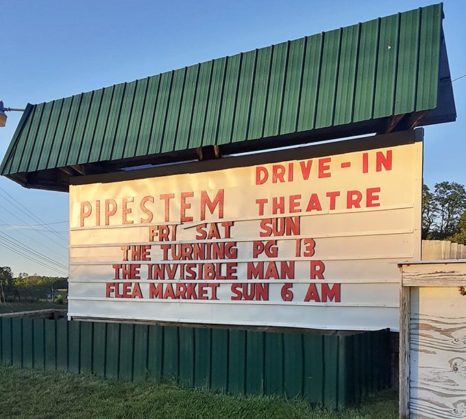 Hand-placed letters on a classic marquee, announcing double features the old-fashioned way, one movie title at a time.