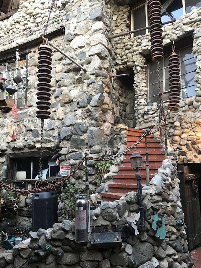 Industrial meets medieval in this stairway where electrical insulators hang like strange fruit. Who needs traditional castle decor when you've got salvaged utility parts?