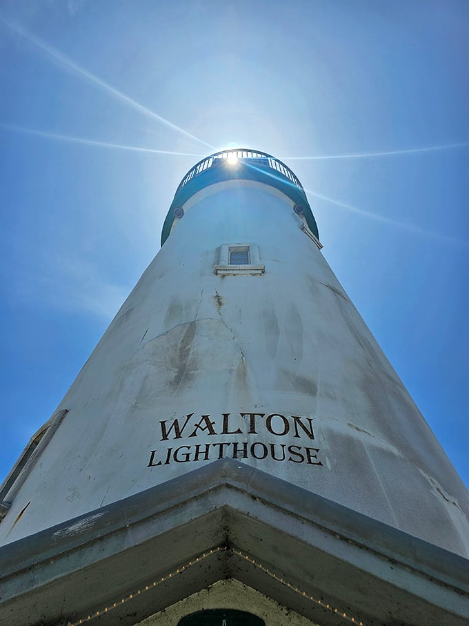 Looking up at Walton's crown, where sunbeams create a celestial halo. It's like the lighthouse is having its own personal spotlight moment.