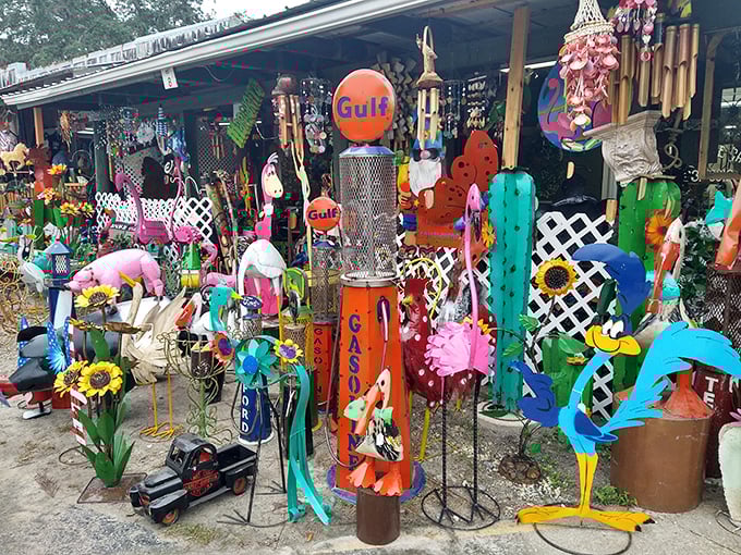 Garden art paradise! Where else can you find a vintage Gulf sign, neon flamingos, and enough metal cacti to start your own desert?