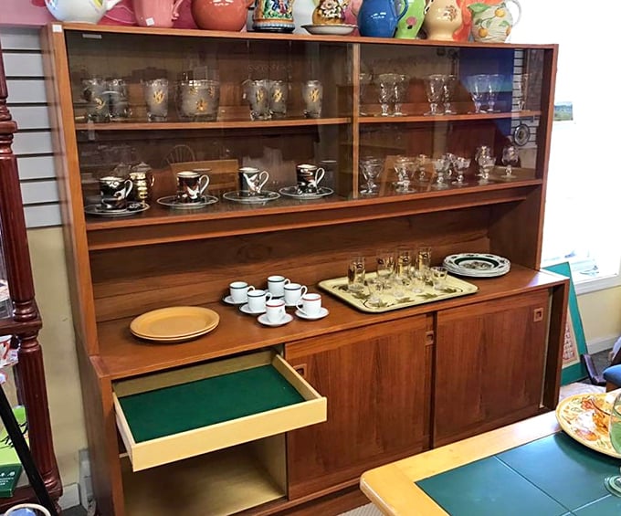 Mid-century modern meets vintage elegance in this wooden hutch. Each teacup and glass tells a story&mdash;just waiting for you to write the next chapter.