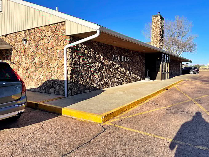 That stunning stone facade tells you Archie's takes its steakhouse business seriously, like a fortress protecting perfectly grilled treasures inside.