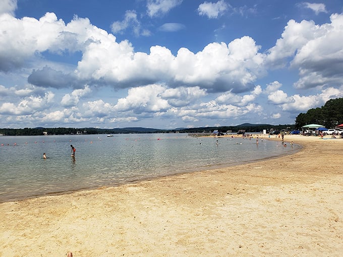 Heaven's cotton candy clouds reflect in calm waters while beachgoers create memories that'll outlast any suntan.