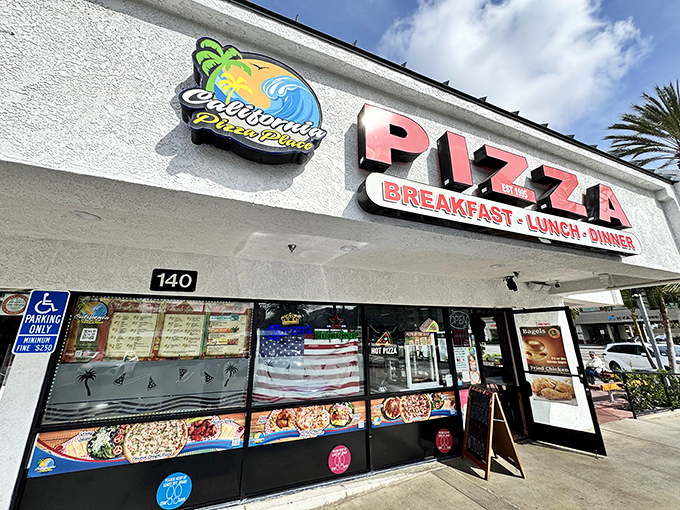 California Pizza Place's beachside vibe shines through its colorful sign, where pizza meets paradise for breakfast, lunch, and dinner.