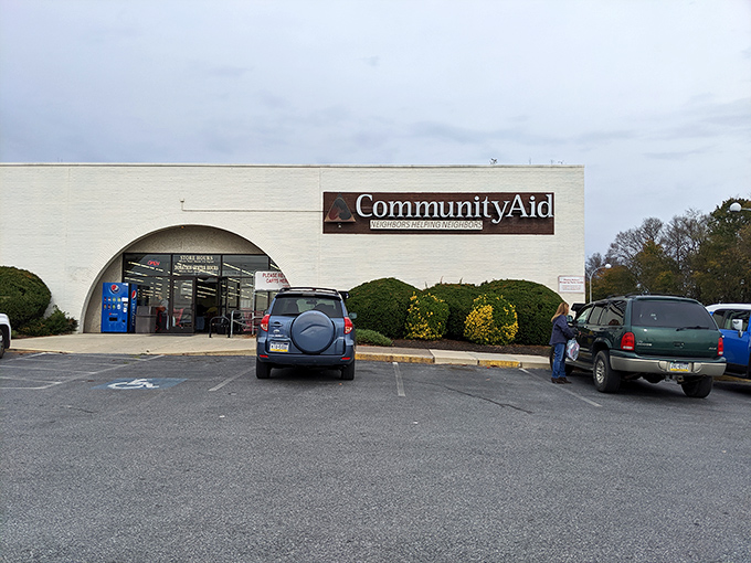 Community Aid's distinctive arched entrance welcomes shoppers into a world of organized chaos. The white brick exterior belies the colorful finds inside.