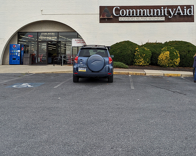 Community Aid's welcoming entrance promises "Neighbors Helping Neighbors" and treasures beyond that automatic door.