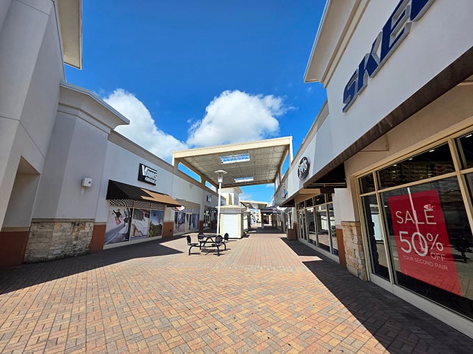 Brick walkways and modern storefronts at Grand Prairie Premium Outlets &ndash; where your credit card gets its steps in.