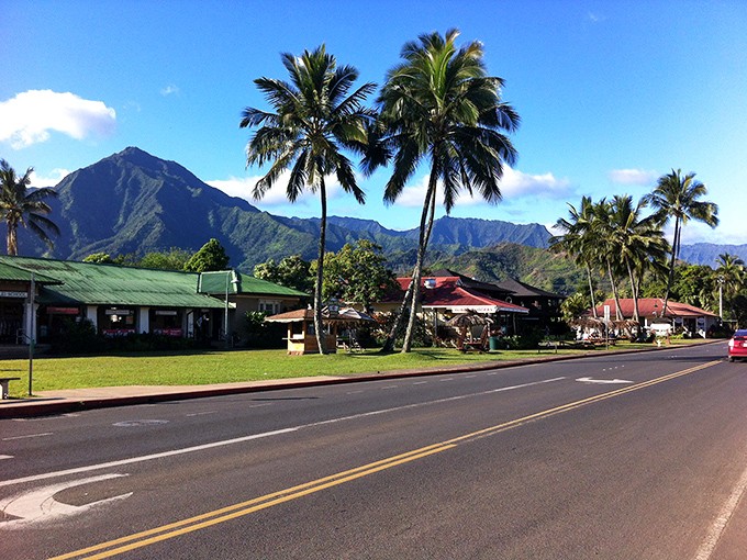 Hanalei's breathtaking mountain backdrop frames this paradise where lush peaks meet palm trees.