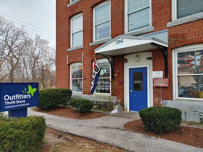 Outfitters Thrift Store's charming brick building and blue door promise adventures in secondhand shopping.