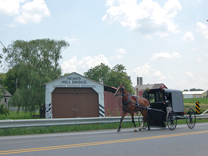 This covered bridge stands like a wooden guardian, protecting travelers just as it has for generations past.