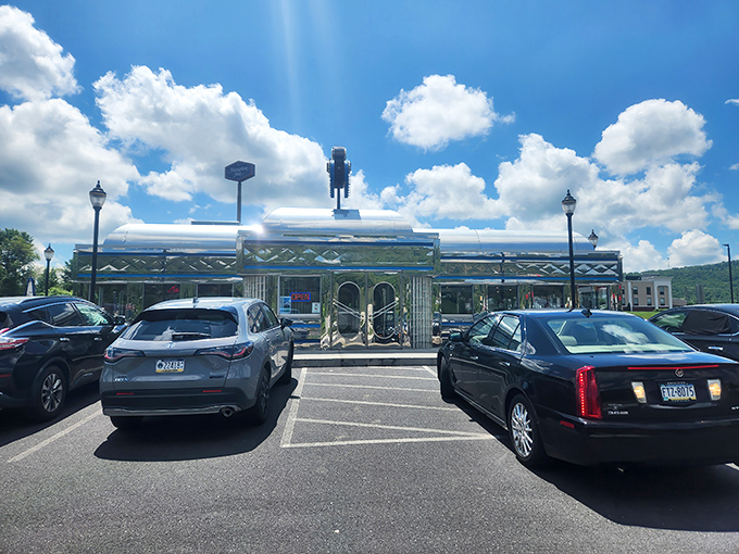 This shiny diner sits proudly against a perfect blue sky, topped with a robot-like figure that seems to say "resistance to pancakes is futile."