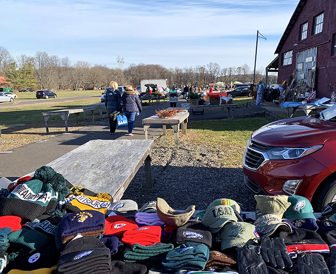 Sports caps and team gear line the tables, perfect for finding that vintage hat you've been hunting for.