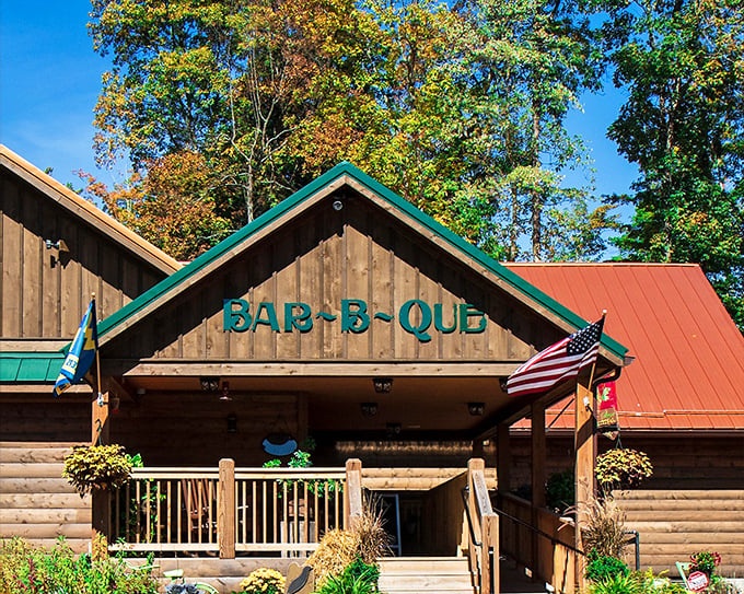 Smoke on the Water's log cabin exterior looks like it belongs on a postcard. The green "BAR-B-QUE" sign is nature's way of saying "lunch is served."