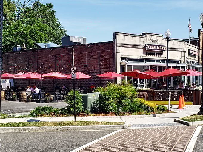 Texas Jack's outdoor patio: where the red umbrellas are as bold as the brisket flavors waiting inside.