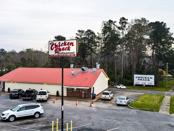 The Chicken Shack's bright red roof serves as a beacon for hungry travelers. Follow the locals to find the good stuff!